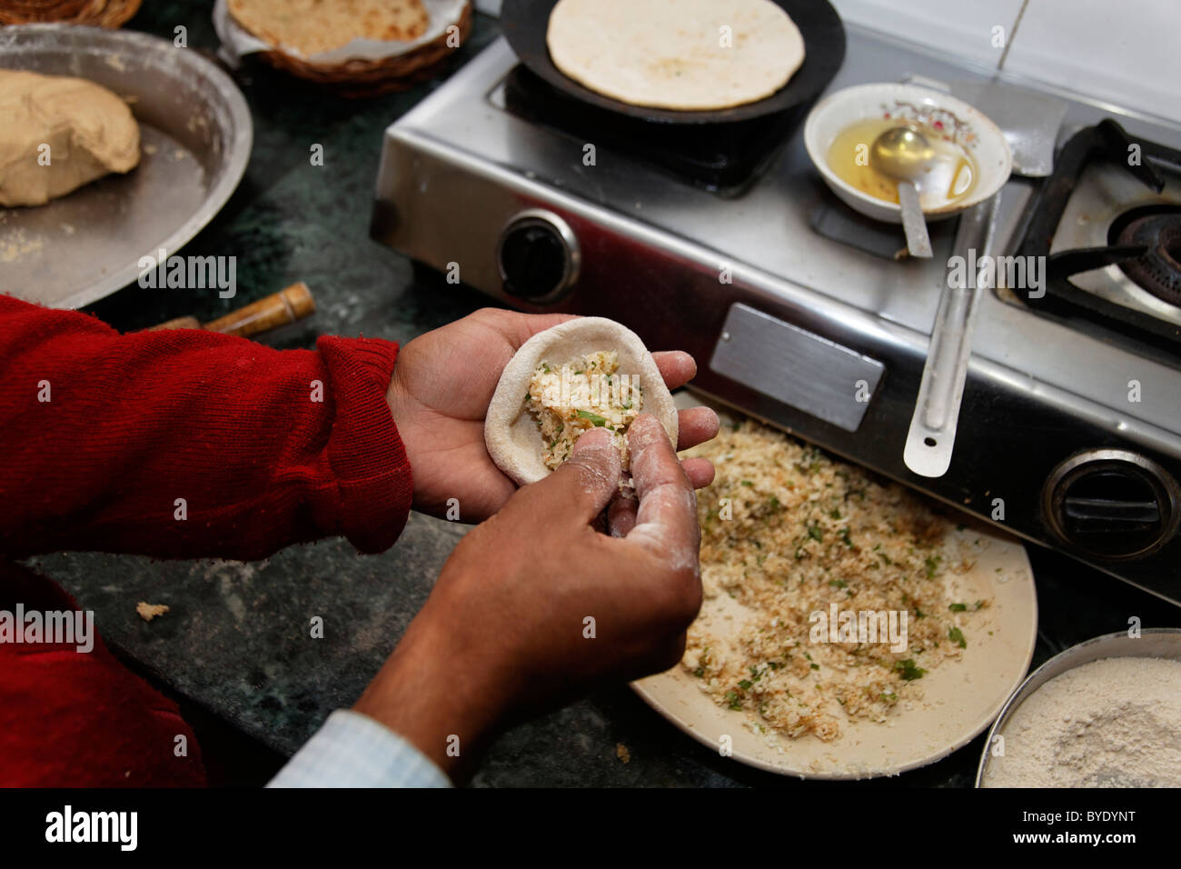 Preparation of paratha, Indian bread with spicy filling, Bhowali ...
