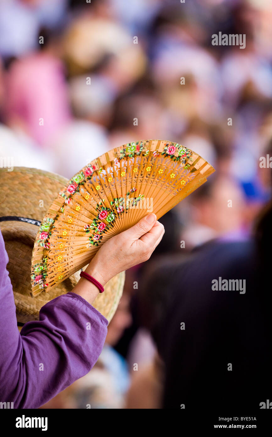 Fan / fans in the hand of a women audience member / crowd / spectators ...