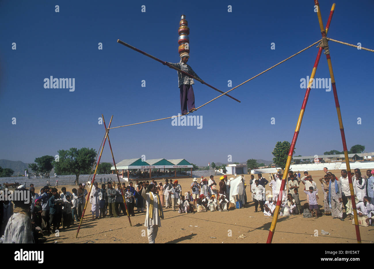 Rope acrobat, tight rope walker, Indian boy with water jugs balanced on ...