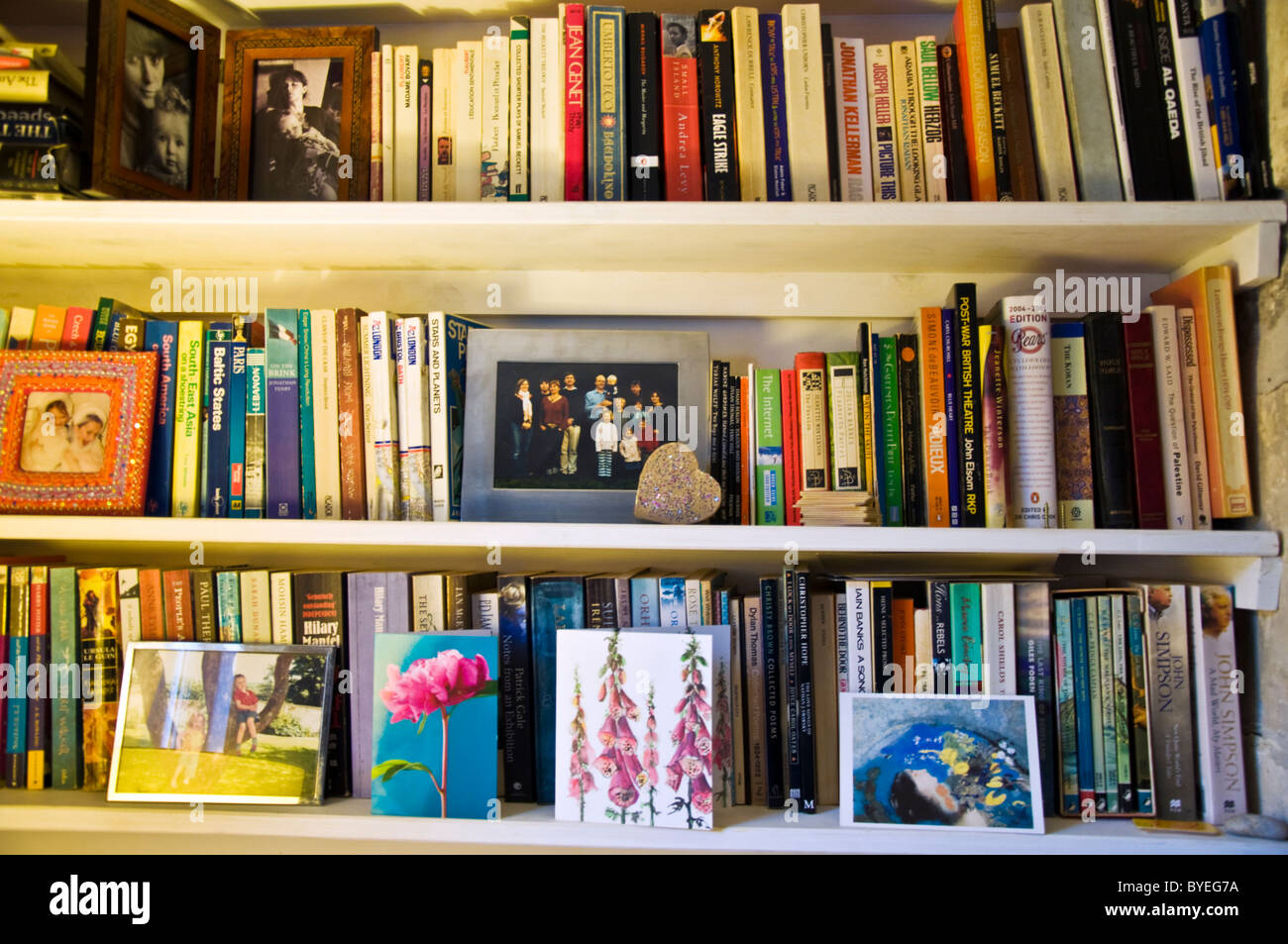 Bookshelf with family photos and cards Stock Photo - Alamy