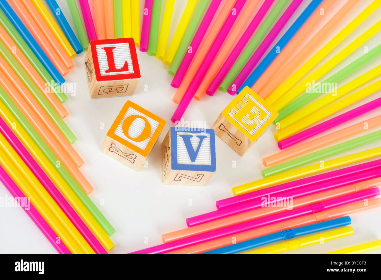 Colorful Straws make a heart shape and childrens blocks spell the word ...