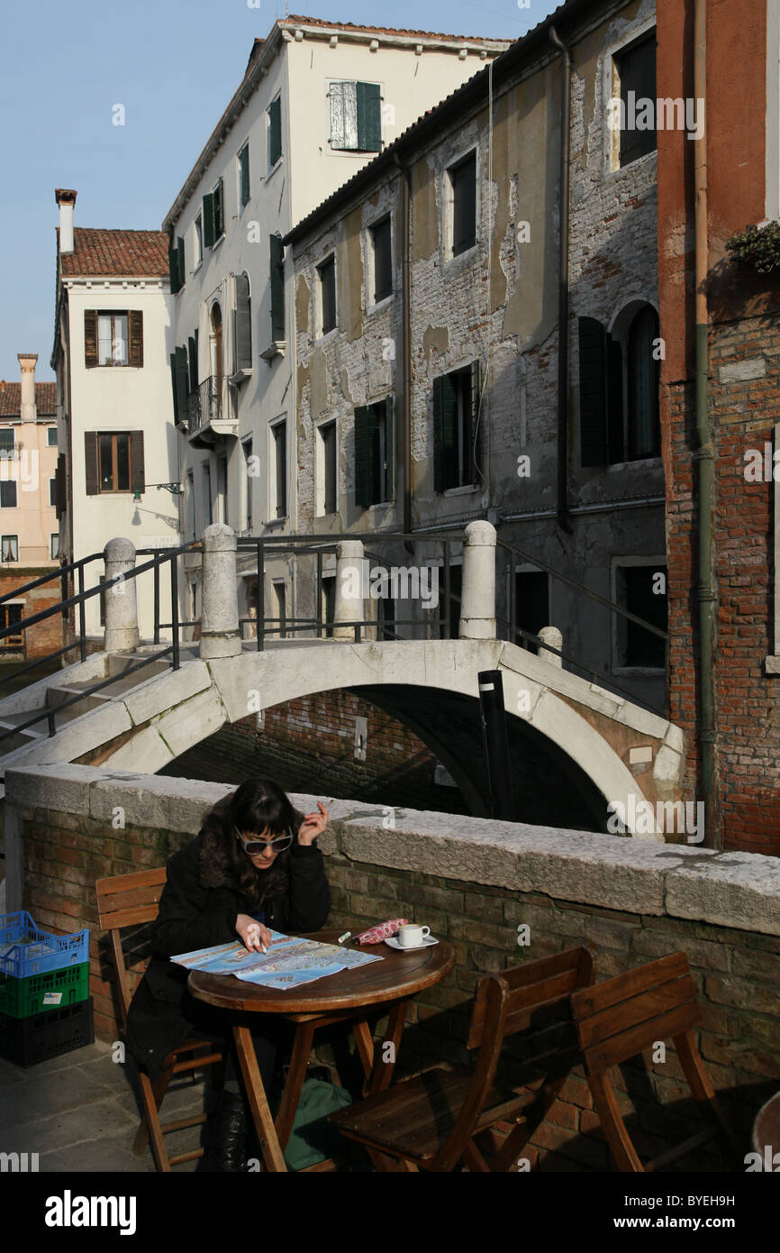 A lone tourist looking at a map while siting in a coffeehouse in the ...