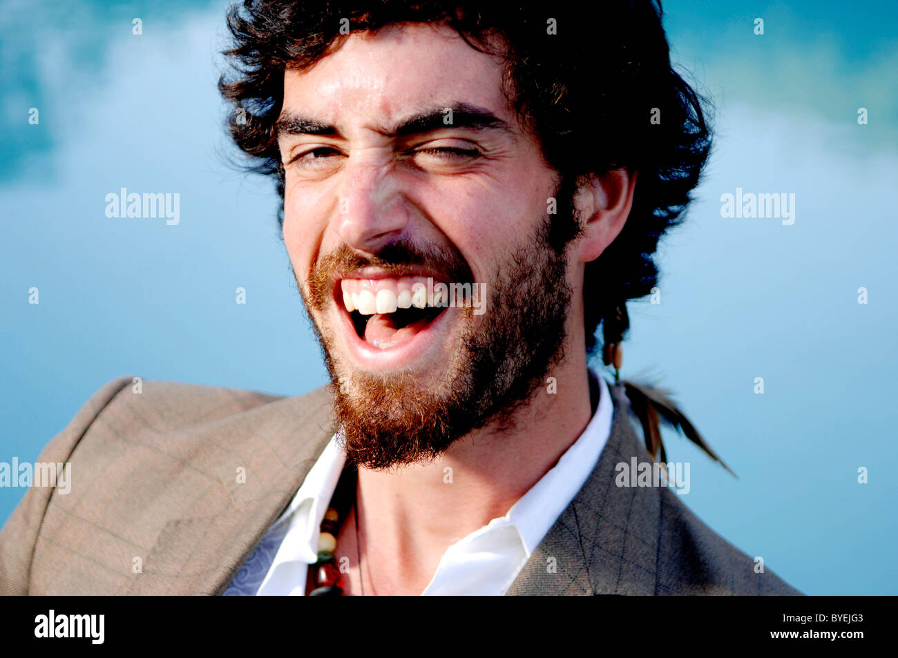 A happy young man laughing having fun by a swimming pool Stock Photo ...