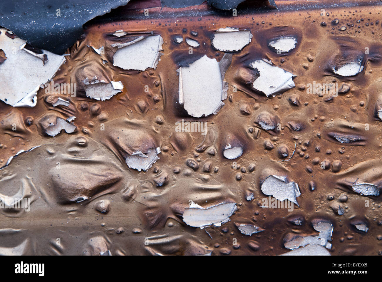 Burnt paint on a Mercedes van that had caught fire. There are flakes of ...