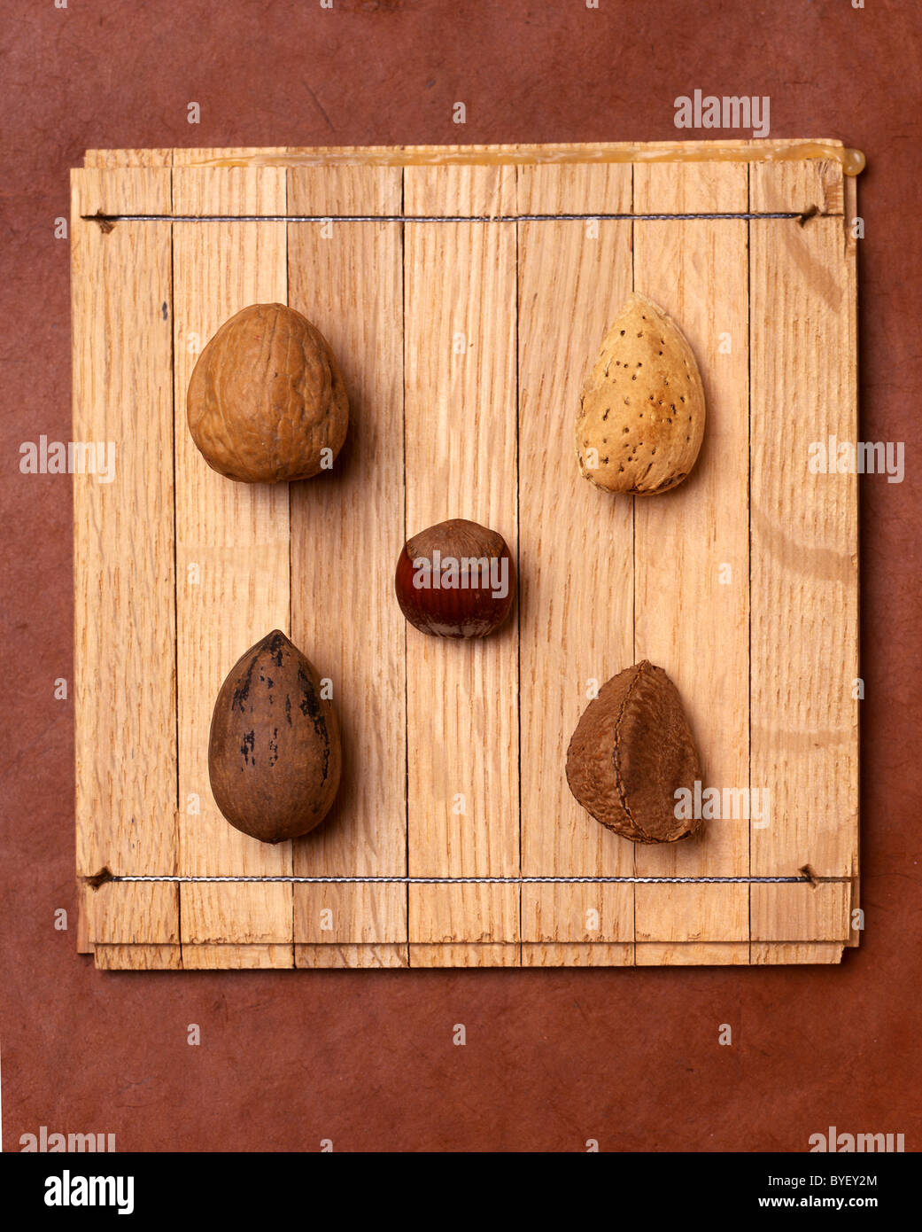 four kinds of nuts in the shell sitting on a board Stock Photo - Alamy