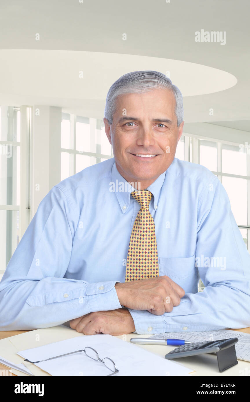 Middle aged Businessman Seated at His Desk in Modern Office Setting ...