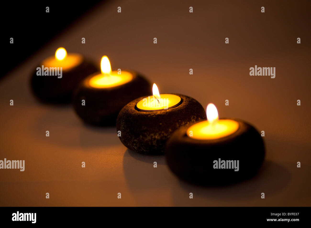 Row of small candles on a table Stock Photo - Alamy