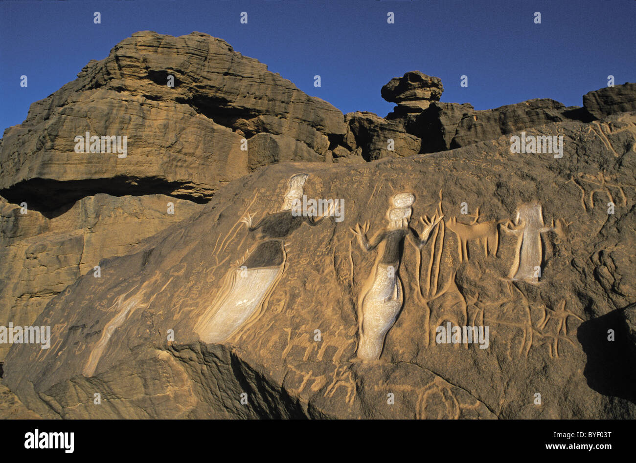 Human figures carved into rock face in Niger Stock Photo - Alamy