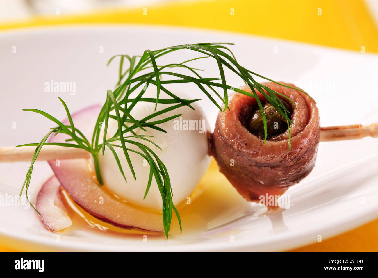 Mozzarella cheese and rolled anchovy on a stick Stock Photo - Alamy