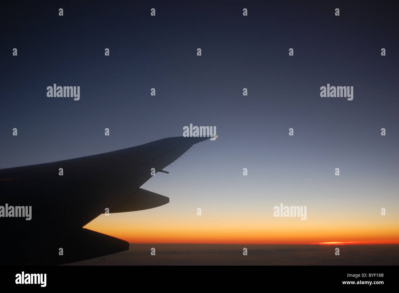 Boeing 777 wing with sunset in the background Stock Photo - Alamy