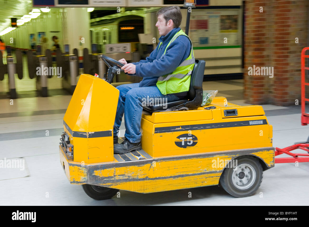 London , Liverpool Street Station , operative drives yellow electric ...