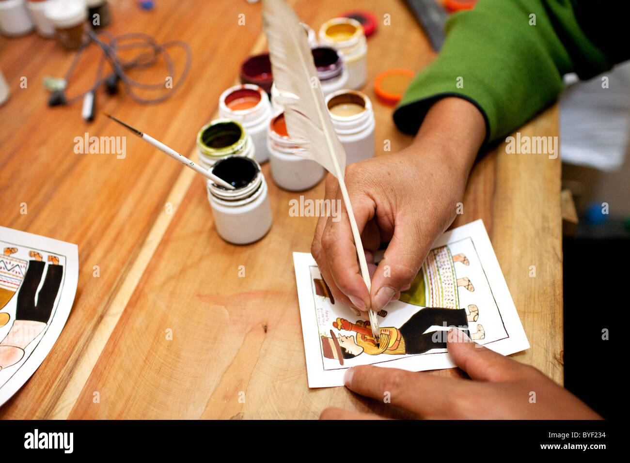 An artist draws traditional Peruvian art using a quill as a drawing ...