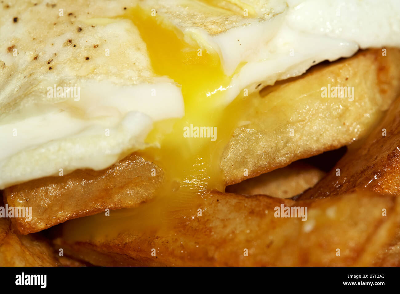 home made egg and chips with egg yolk running over chips Stock Photo ...