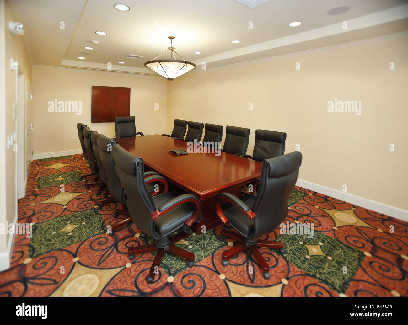 A small executive conference room with table and conference call ...