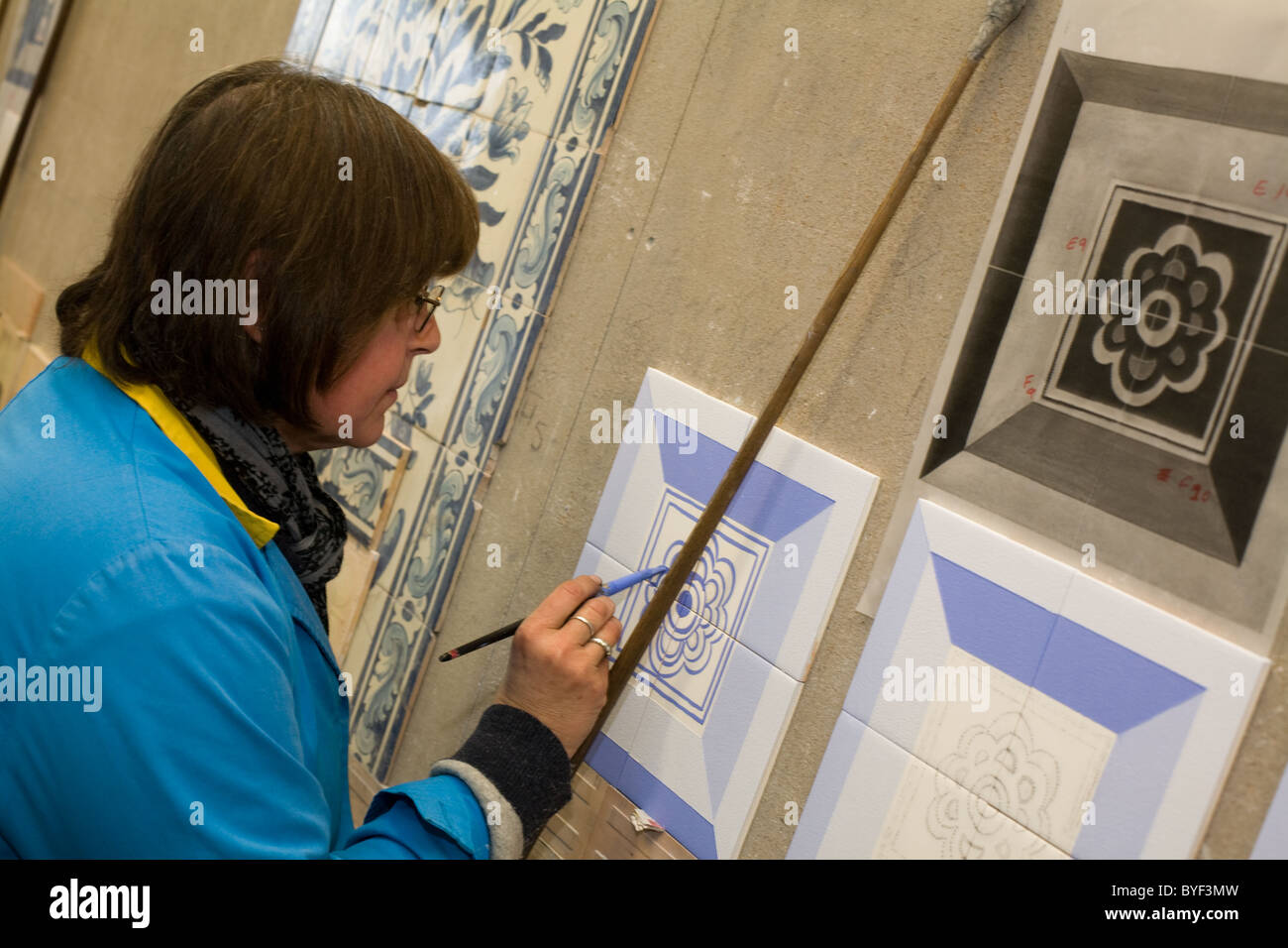 Woman hand apinting a tile design at Viúva Lamego factory near Sintra ...