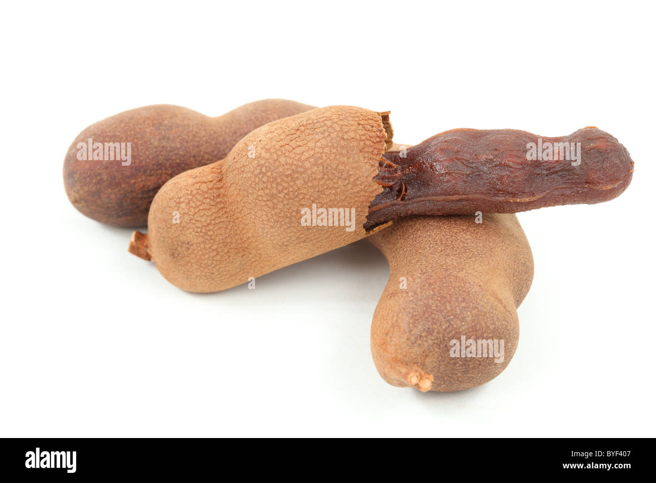 Closeup of tamarind fruits over white background Stock Photo - Alamy