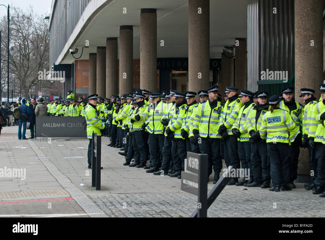 Long line police officers protecting Conservative HQ Millbank Centre ...
