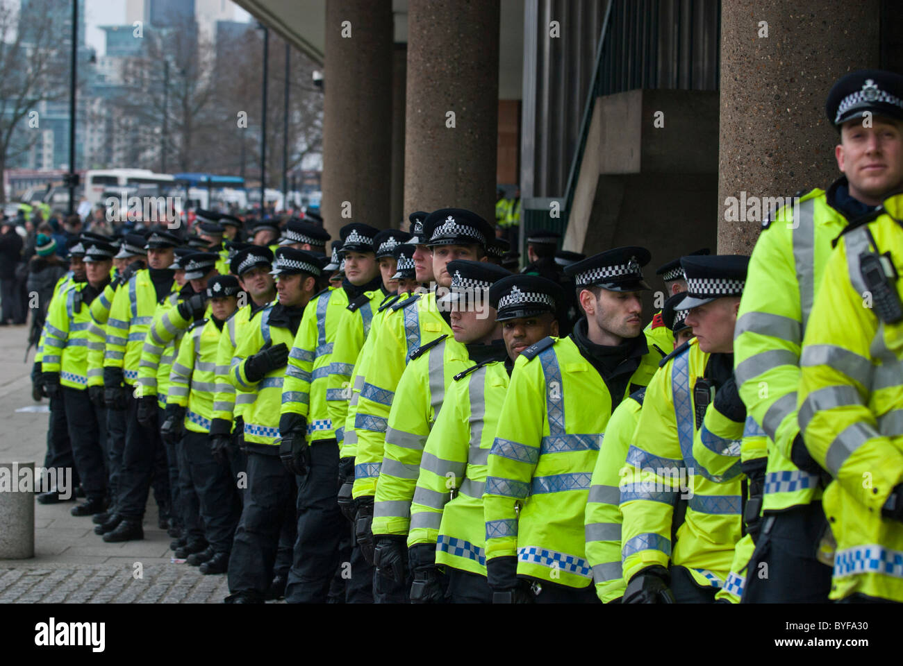 Long line police officers protecting Conservative HQ Millbank Centre ...