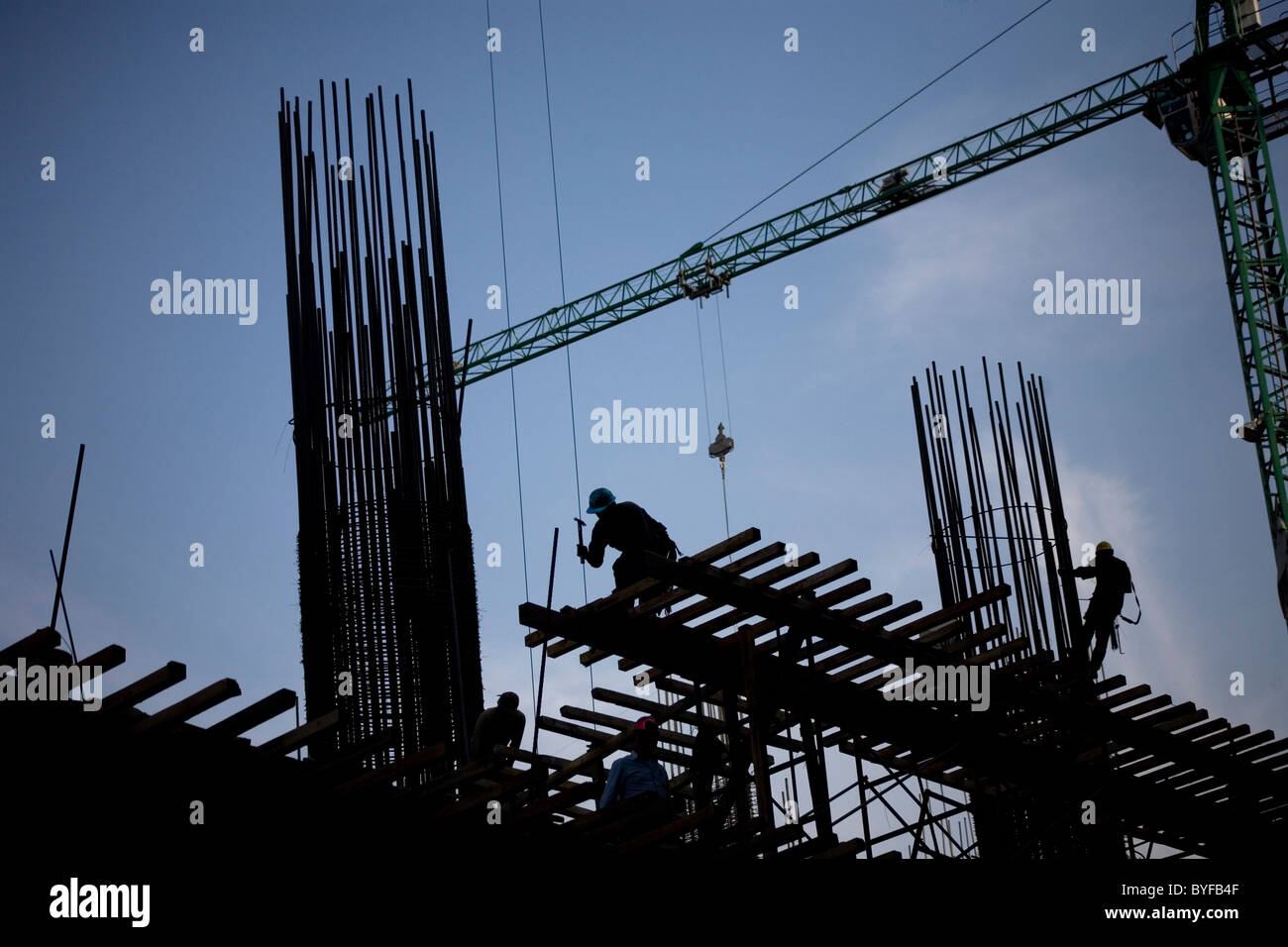 Workers and steel structures of a building construction of a skyscraper ...
