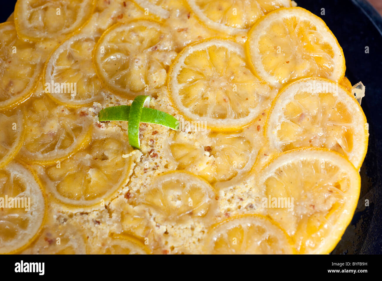 A lemon cake garnished with lemon slices that was prepared in a dutch ...