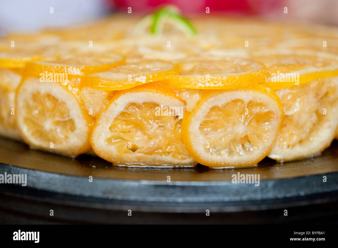A lemon cake garnished with lemon slices that was prepared in a dutch ...