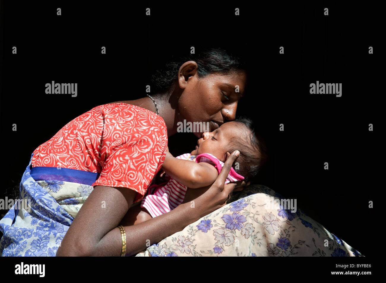 Young South Indian mother cradling her new born baby. Andhra Pradesh ...