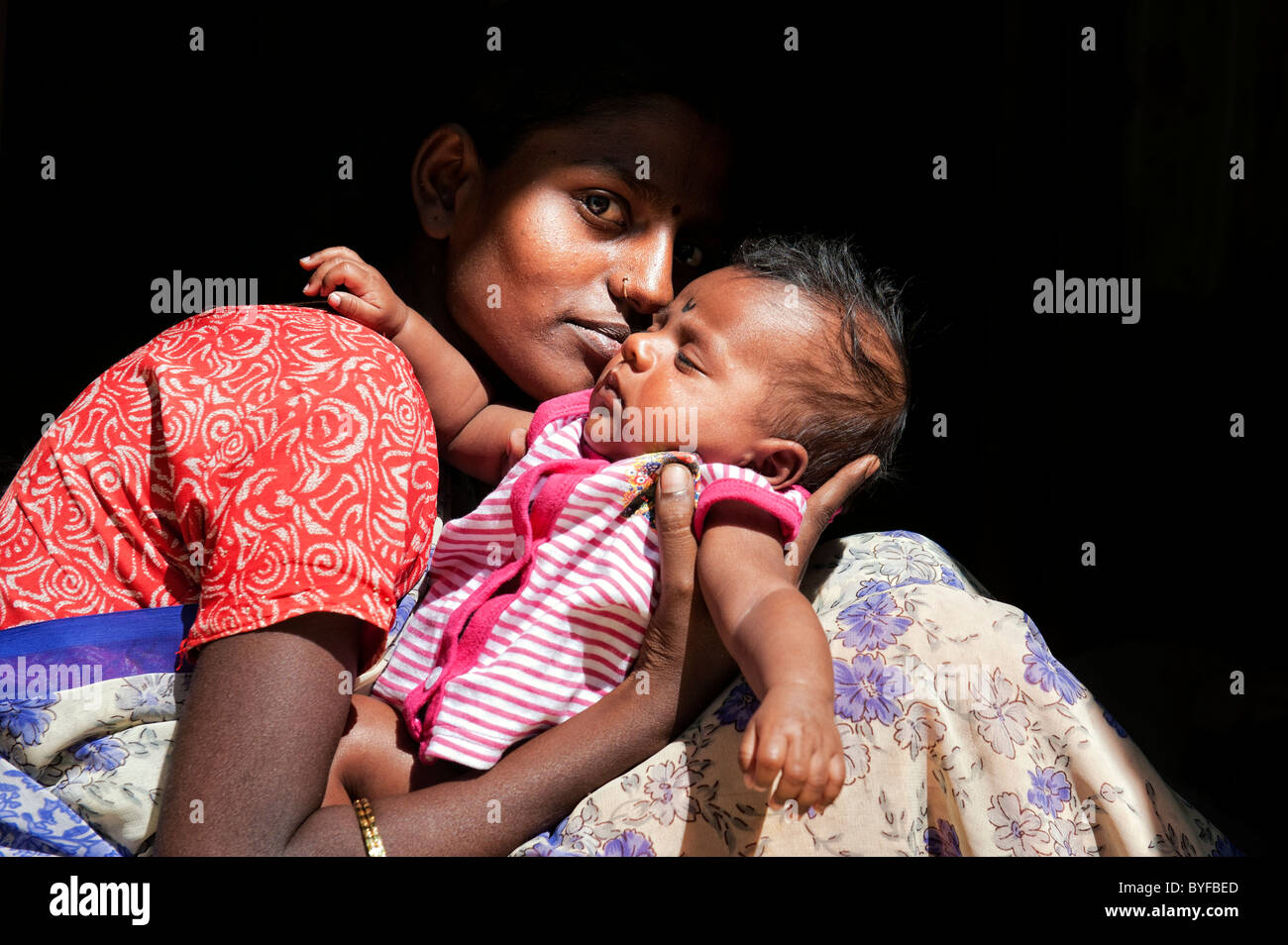 Young South Indian mother cradling her new born baby. Andhra Pradesh ...