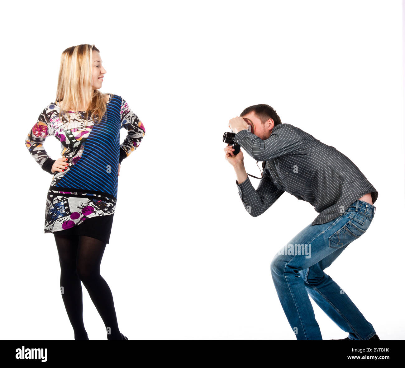 A man photographing a beautiful young woman isolated on white Stock ...