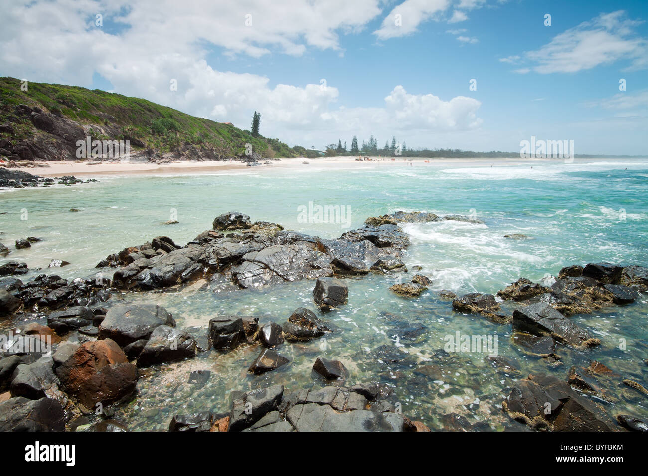 Australian beach during the day with rocks in foreground Stock Photo ...