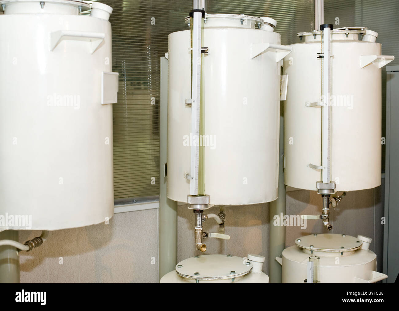 a line of containers for production of alcohol drinks Stock Photo - Alamy
