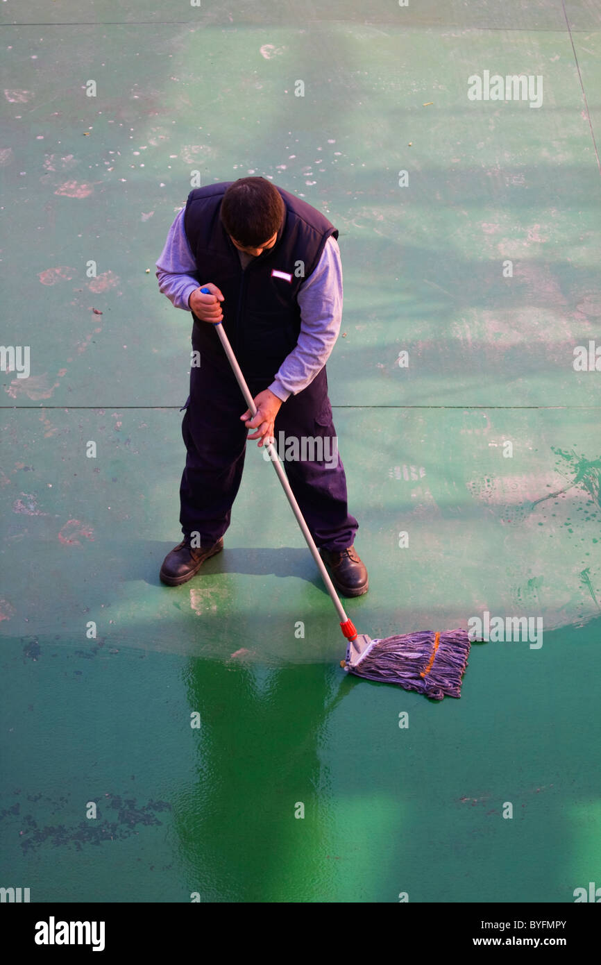 a cleaner is mopping the floor Stock Photo - Alamy