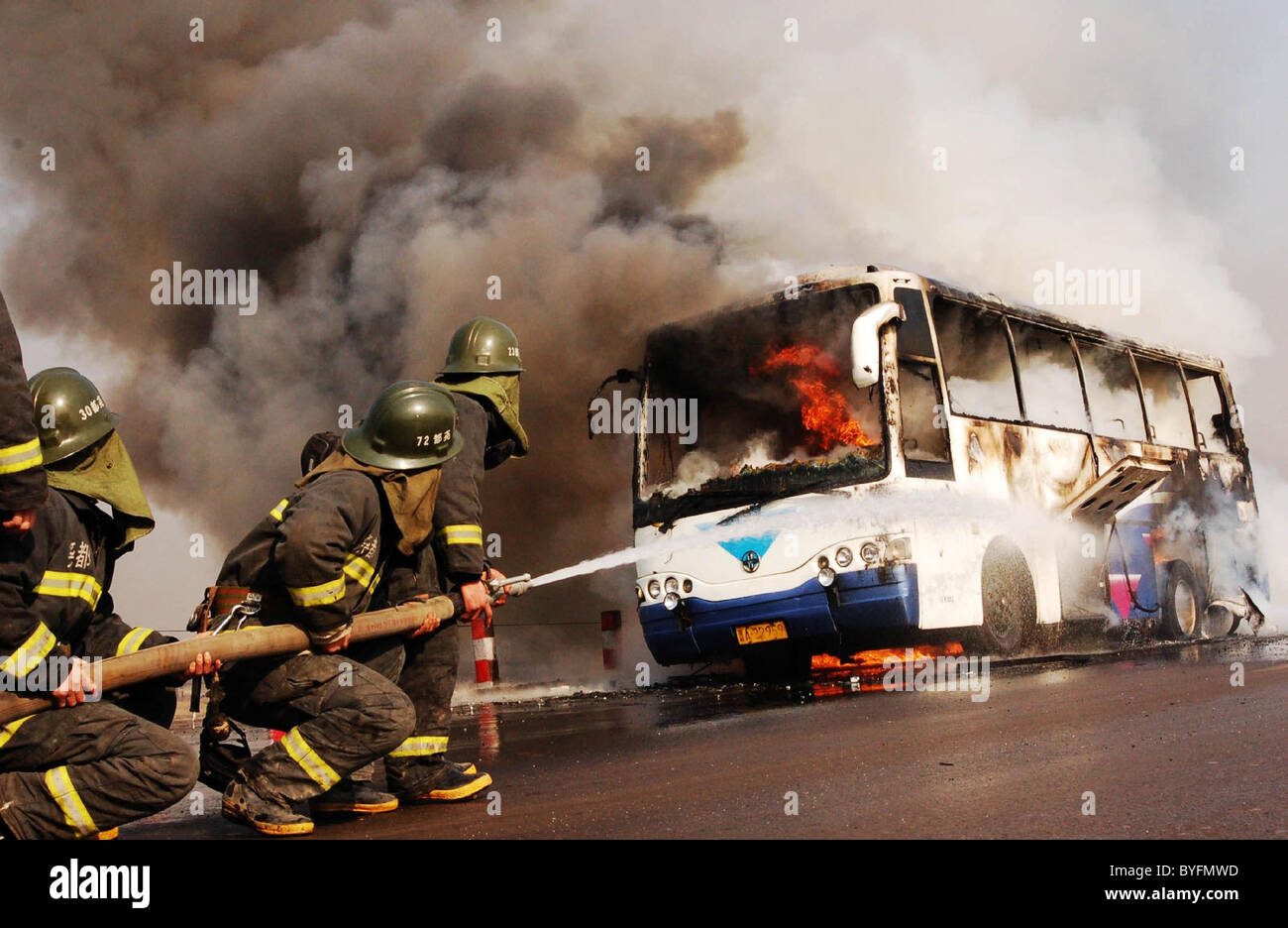 TWENTY-TWO FLEE BUS INFERNO Chinese firefighters battle to control a ...