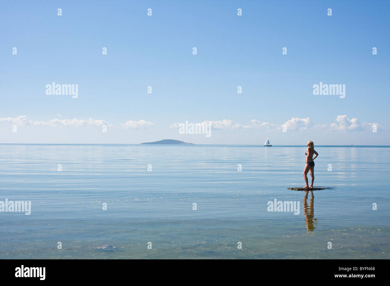Woman wading in sea Stock Photo - Alamy