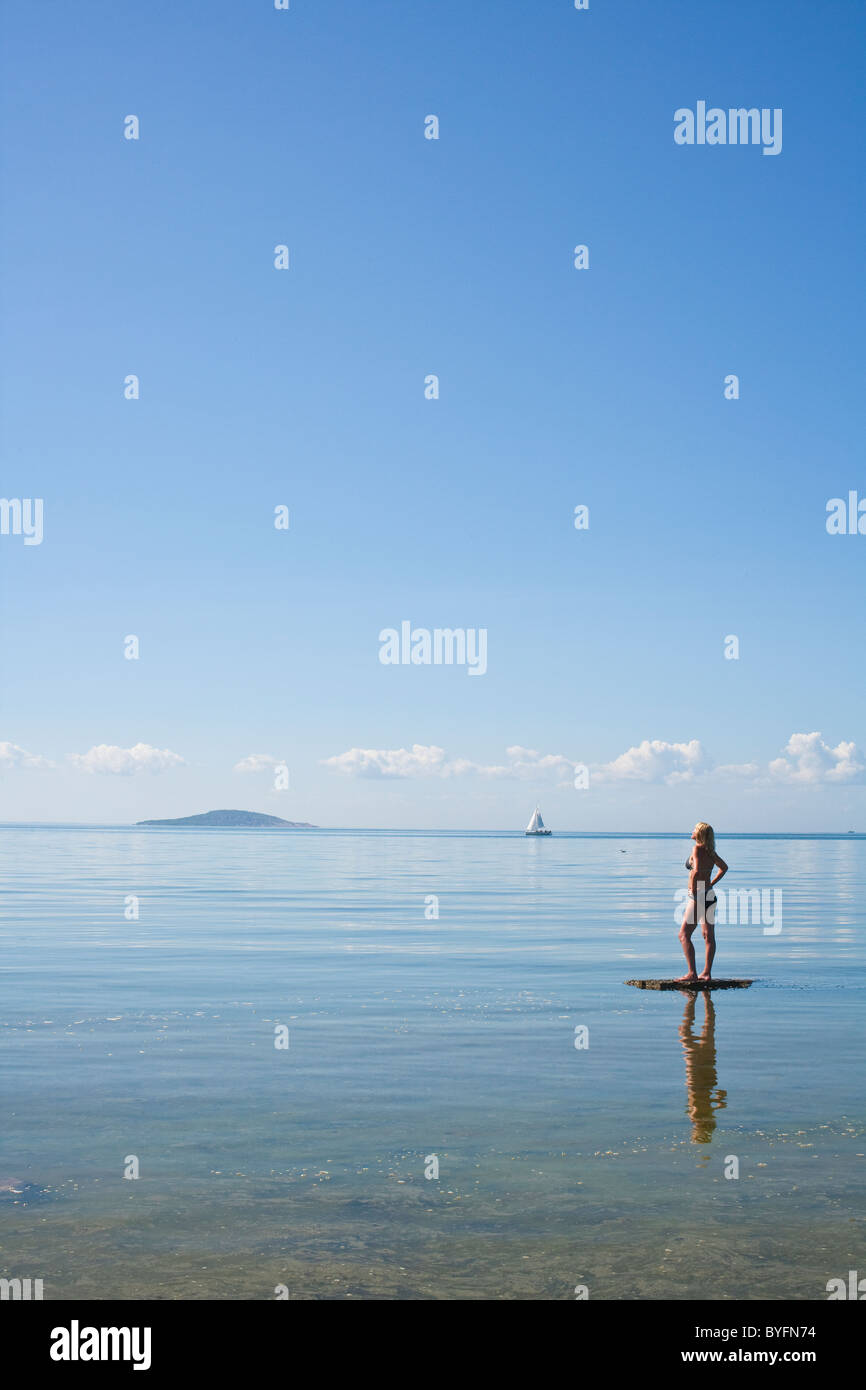 Woman wading in sea Stock Photo - Alamy