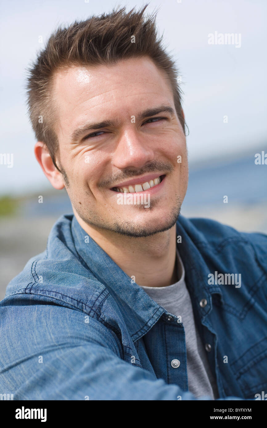 Portrait of man smiling outdoors Stock Photo - Alamy