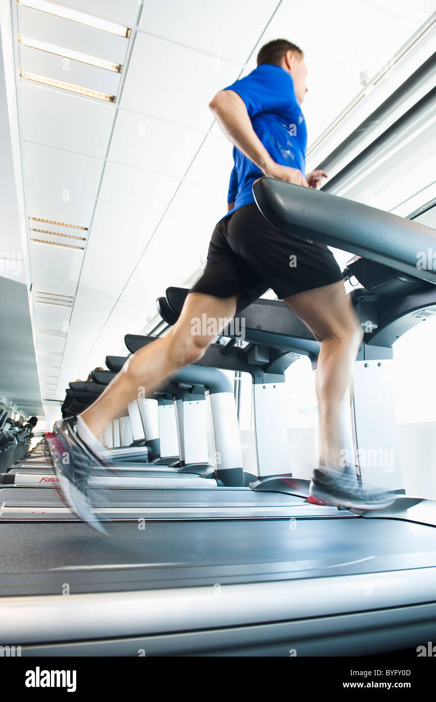 Man running on treadmill in gym Stock Photo - Alamy