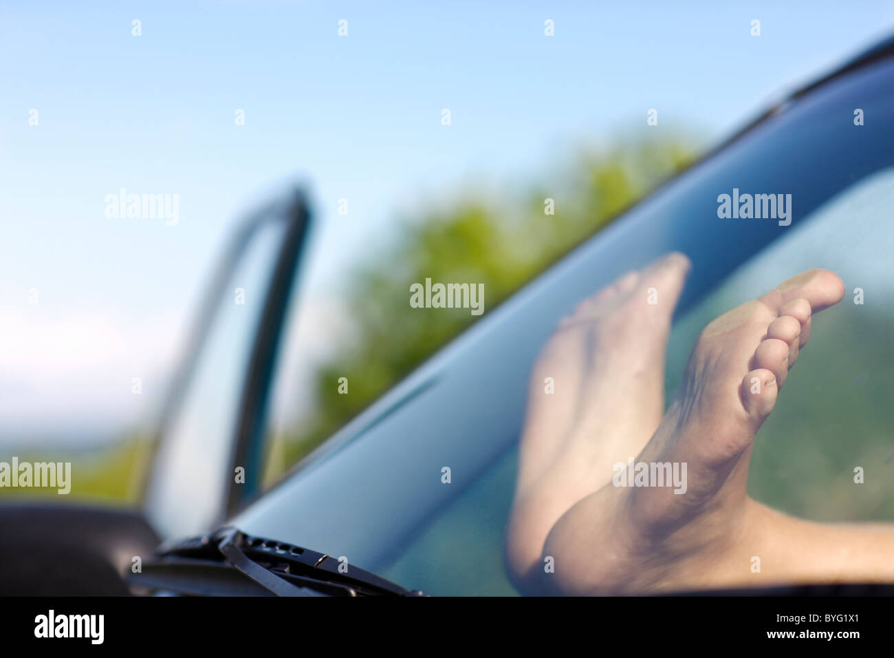 View of barefoot in car through windshield Stock Photo, Royalty Free ...