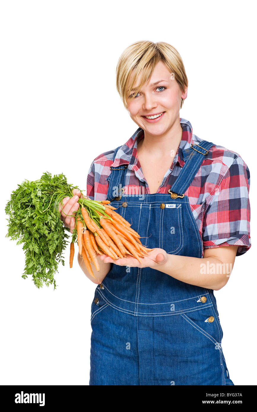Woman Holding Bunch Of Carrot Against White Background Smiling