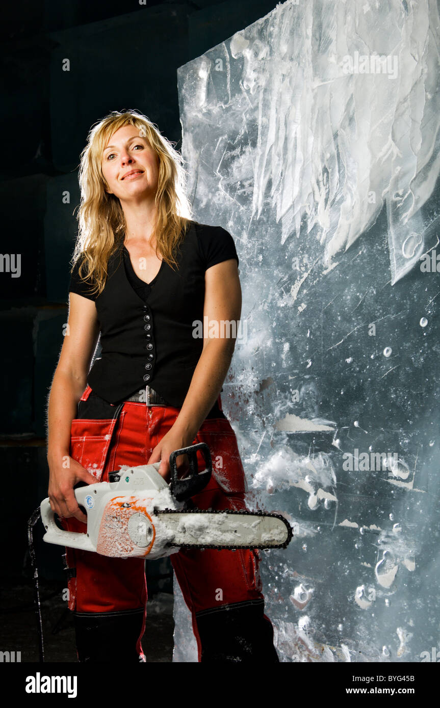 Artist standing with electric saw in front of ice block Stock Photo - Alamy
