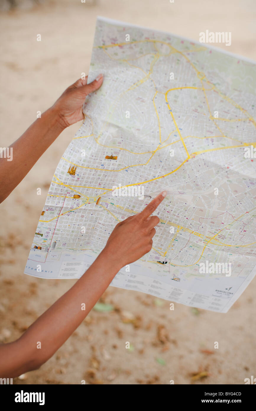 Woman pointing at map Stock Photo - Alamy