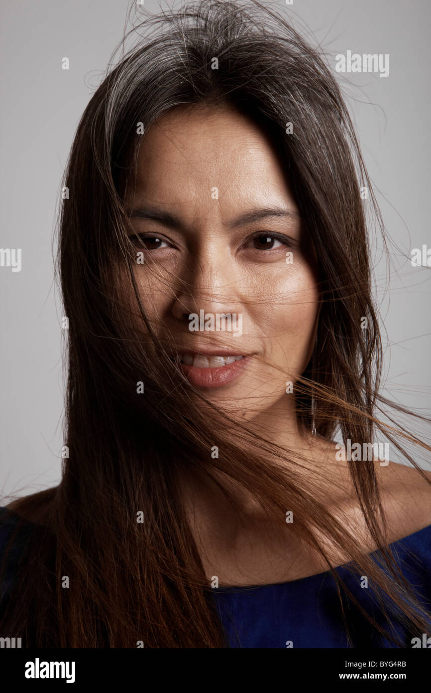 Portrait of woman against grey background Stock Photo - Alamy