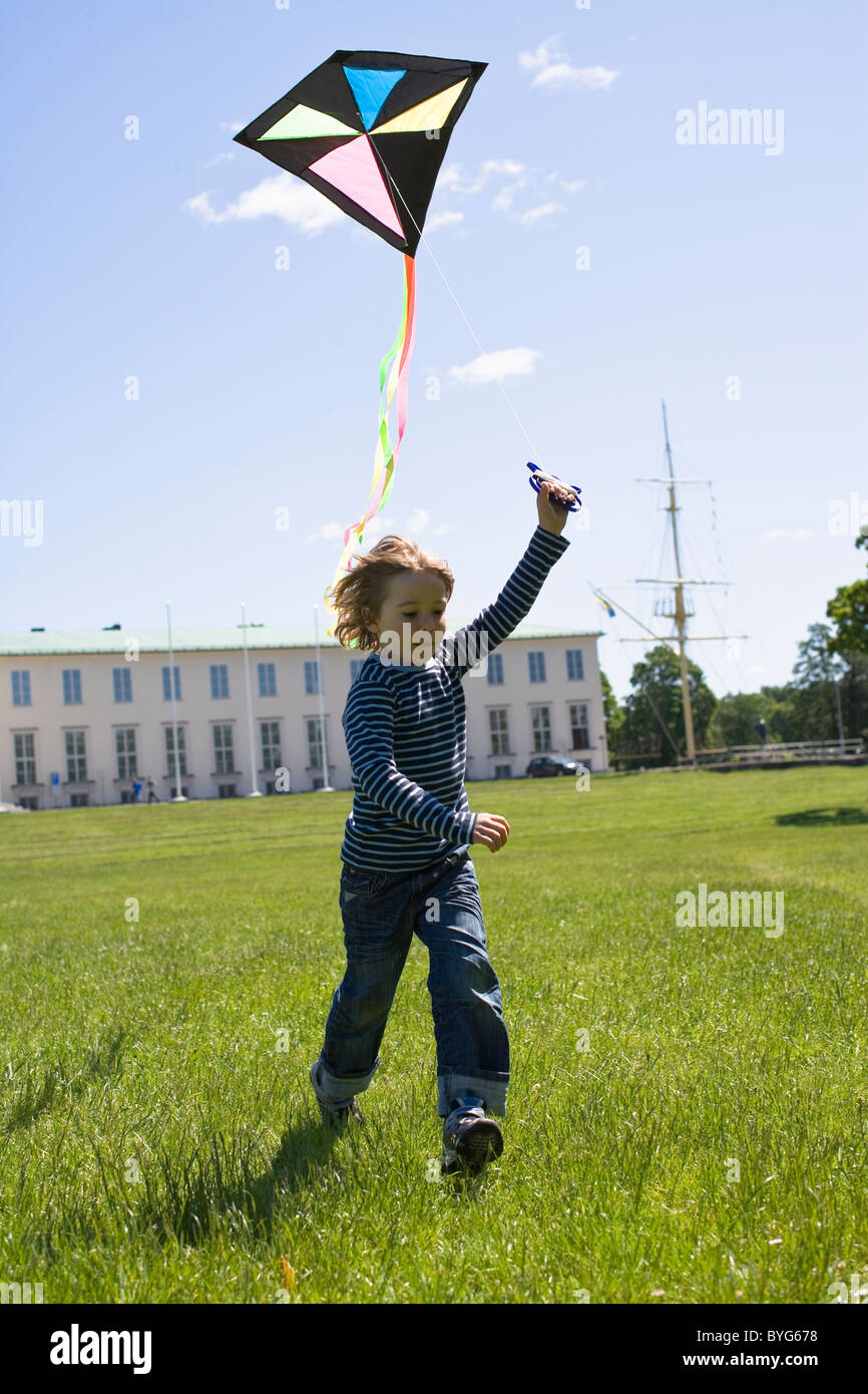 Boy flying kite in bright sunlight Stock Photo - Alamy