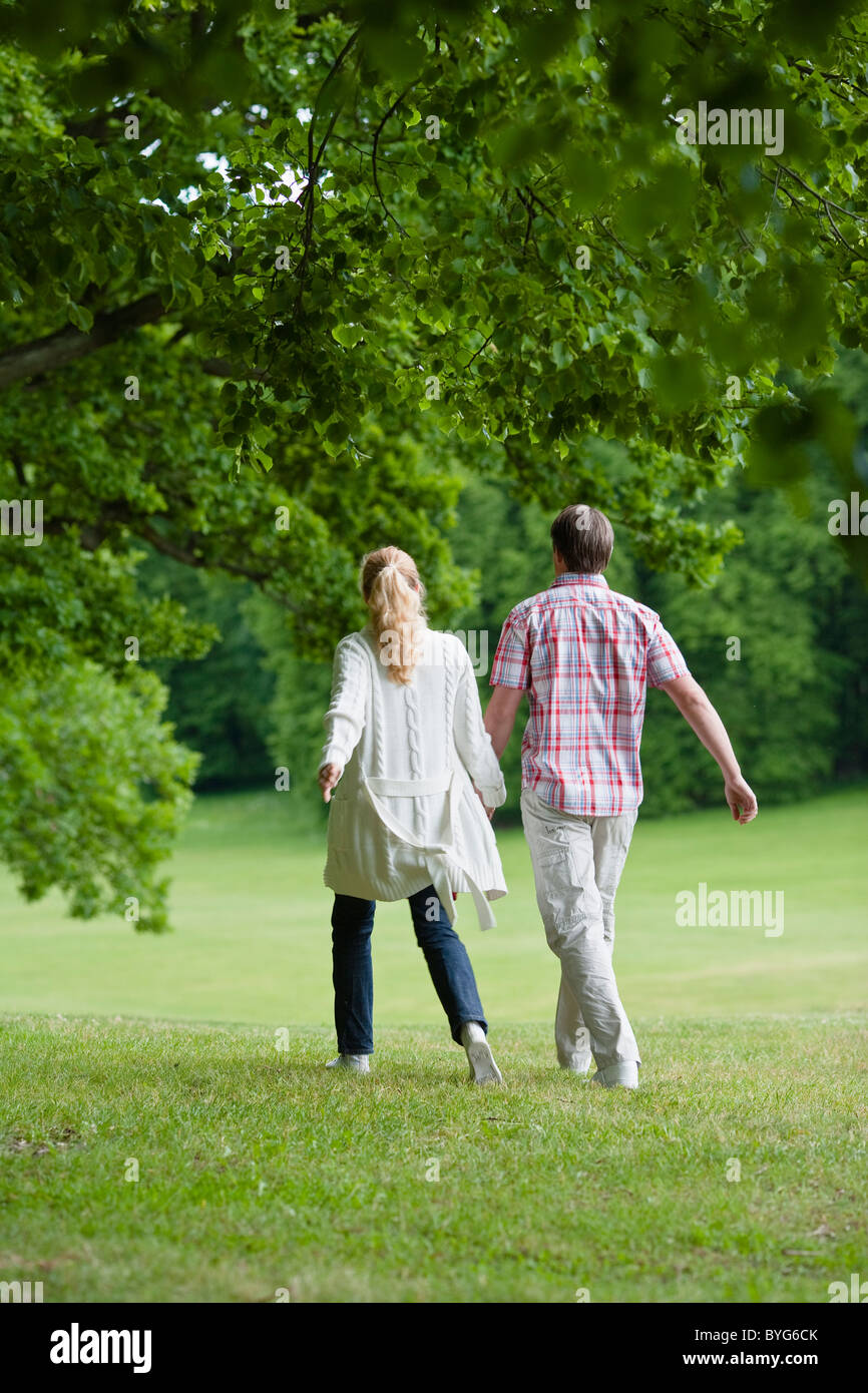 Young couple walking in park Stock Photo - Alamy