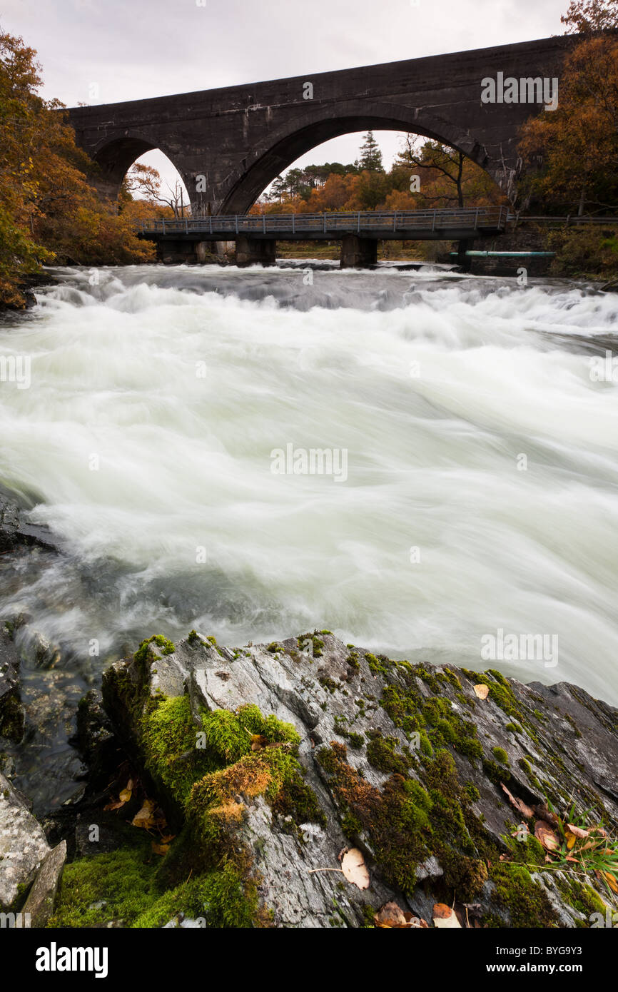 The fast flowing River Morar flows from Loch Morar under the railway ...