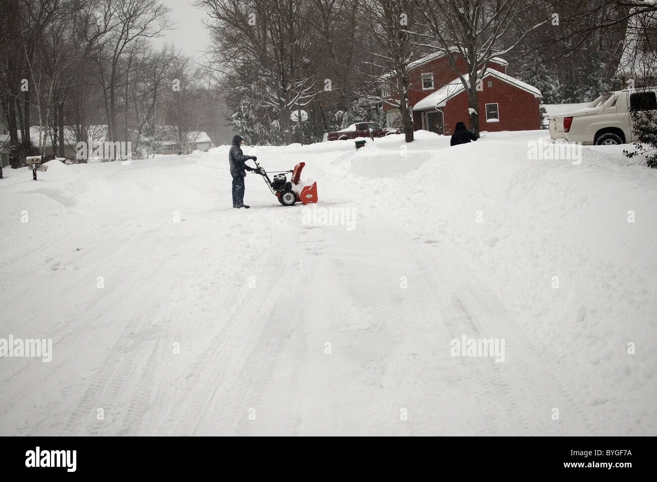 Man clearing snow with snowblower Stock Photo - Alamy