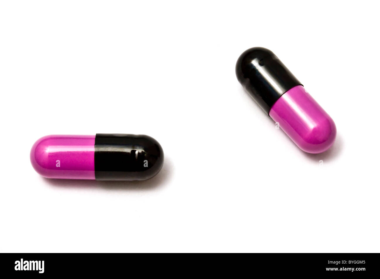 Two capsules isolated on white background Stock Photo - Alamy