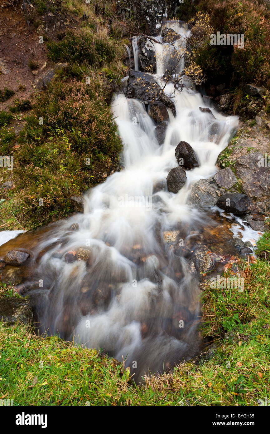 Tumbling waterfall flowing through rich autumn colours in the ancient ...