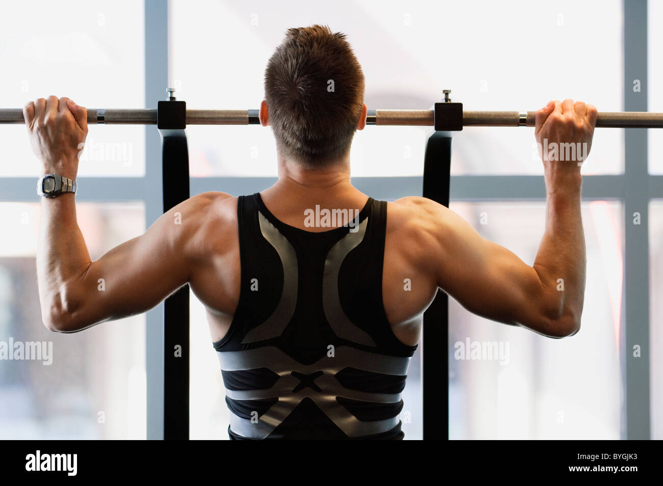 Male athlete doing pull ups in gym Stock Photo - Alamy
