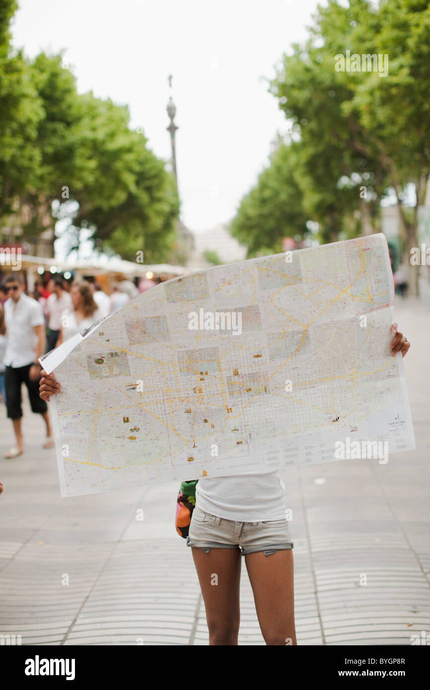 Mid adult woman reading map Stock Photo - Alamy