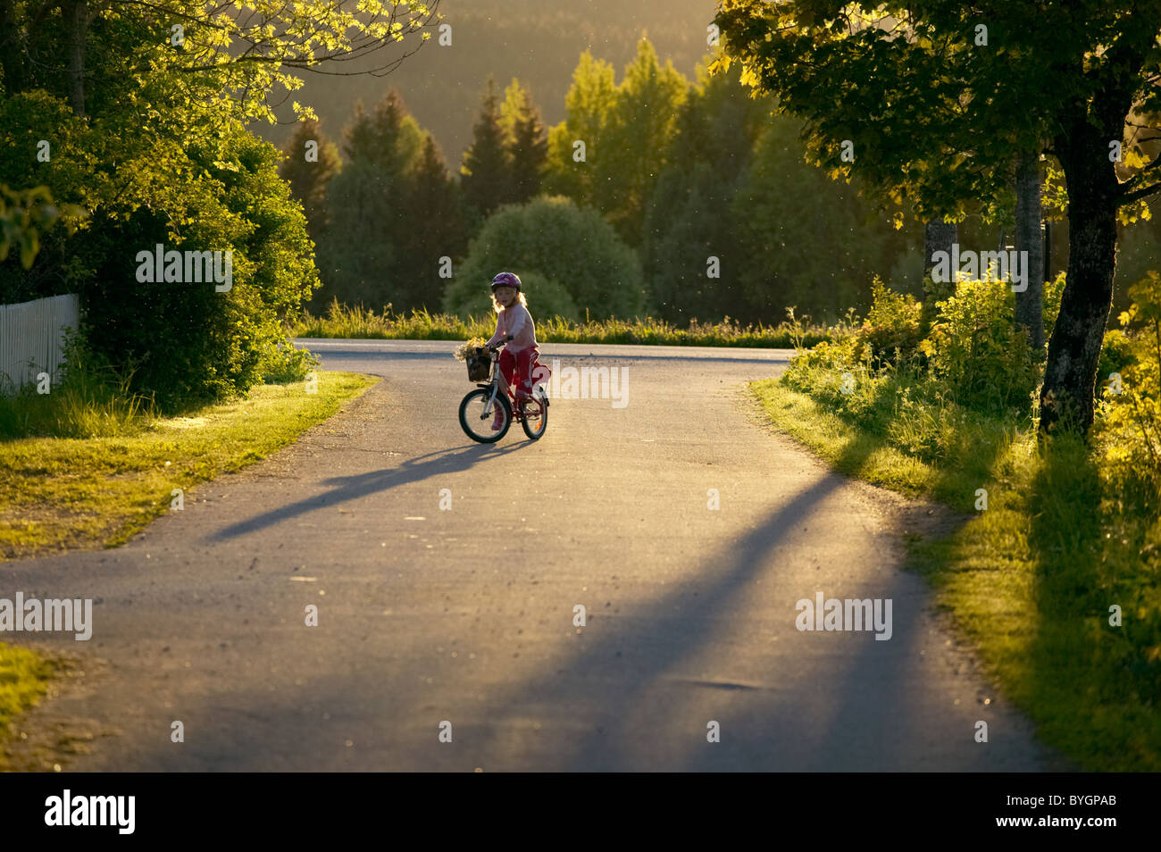 Girl riding bicycle on country road Stock Photo - Alamy